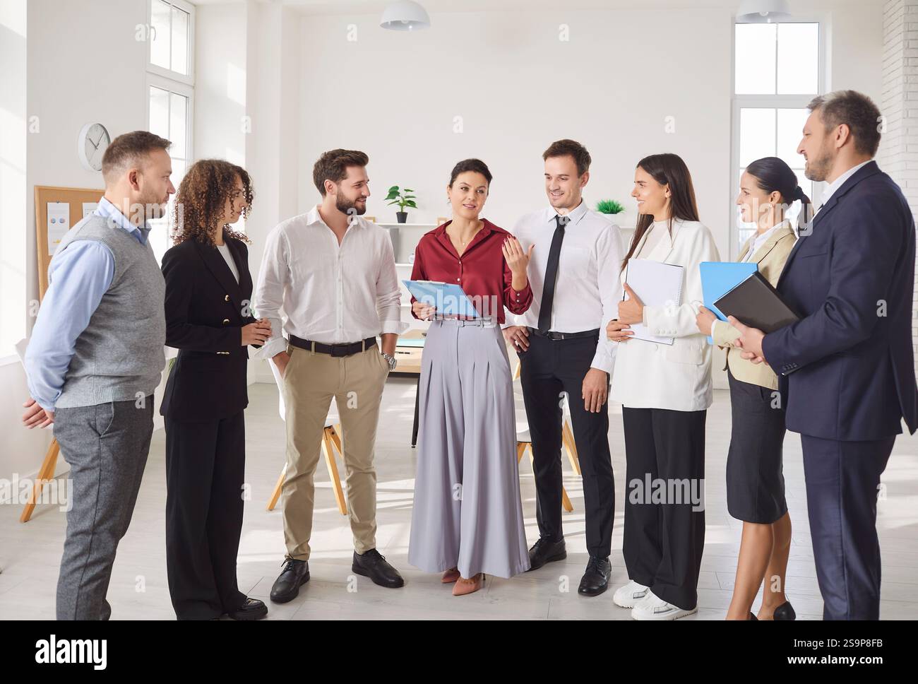 Business Team Engaging In Conversation During Office Presentation Stock ...
