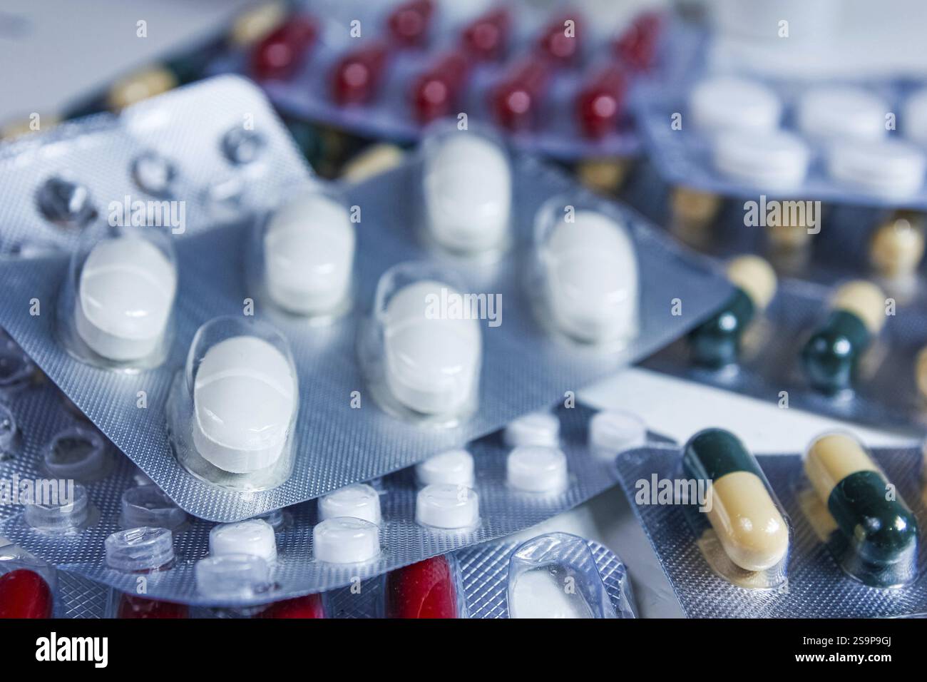 Close-up view of mixed blister packs containing white and colored ...
