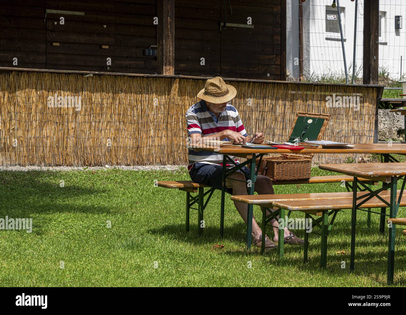 Hobby painter in an empty beer garden, Murnau, Bavaria, Germany, Europe ...