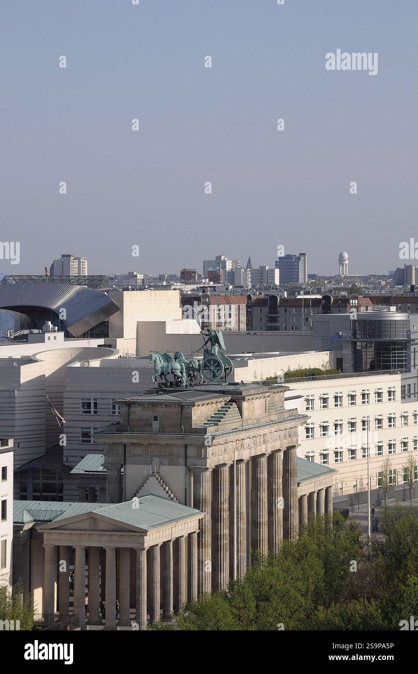 The Brandenburg Gate with Quadriga in the middle of a modern cityscape ...