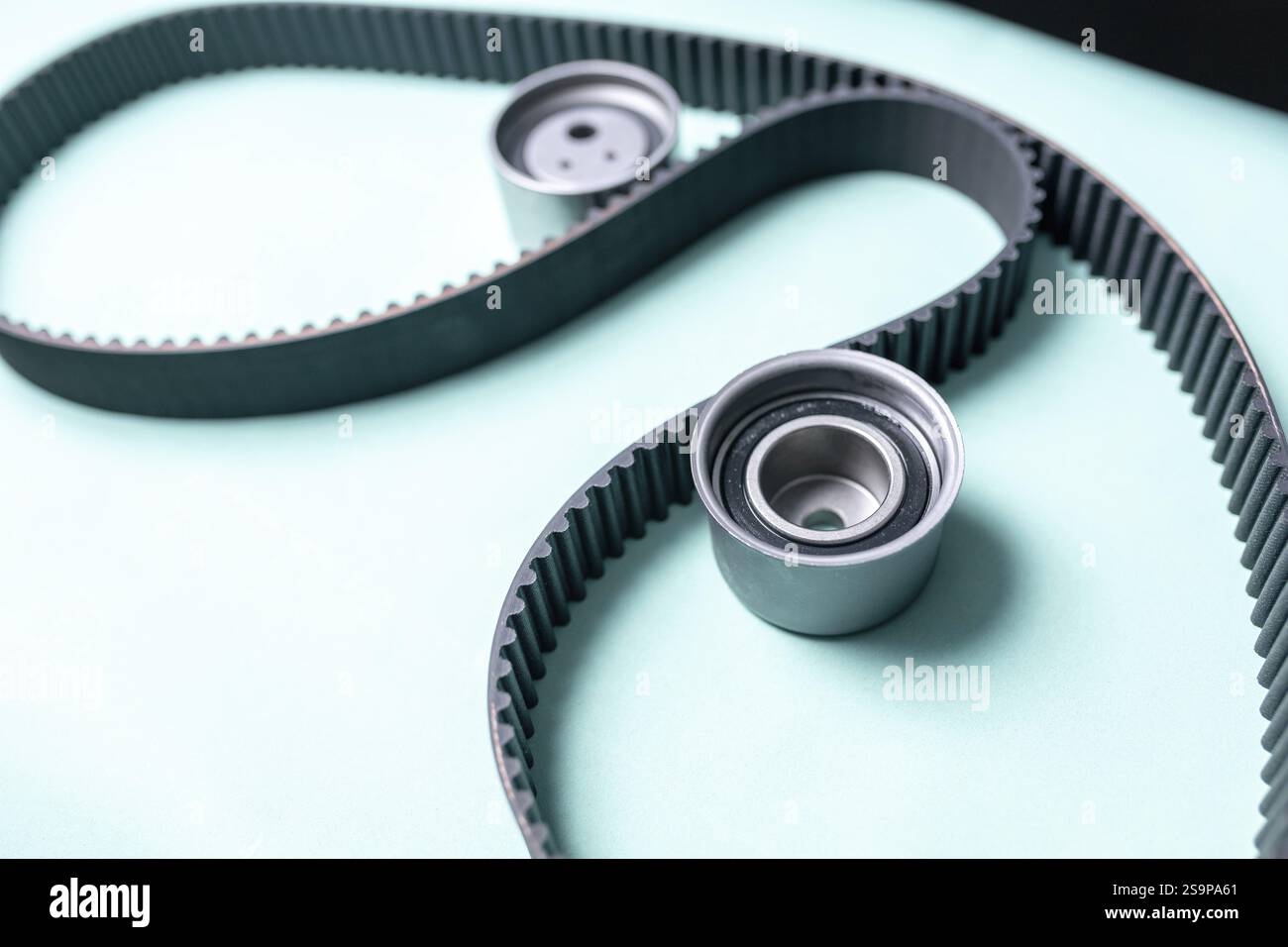Close-up of a timing belt and gears on a mint green background Stock ...