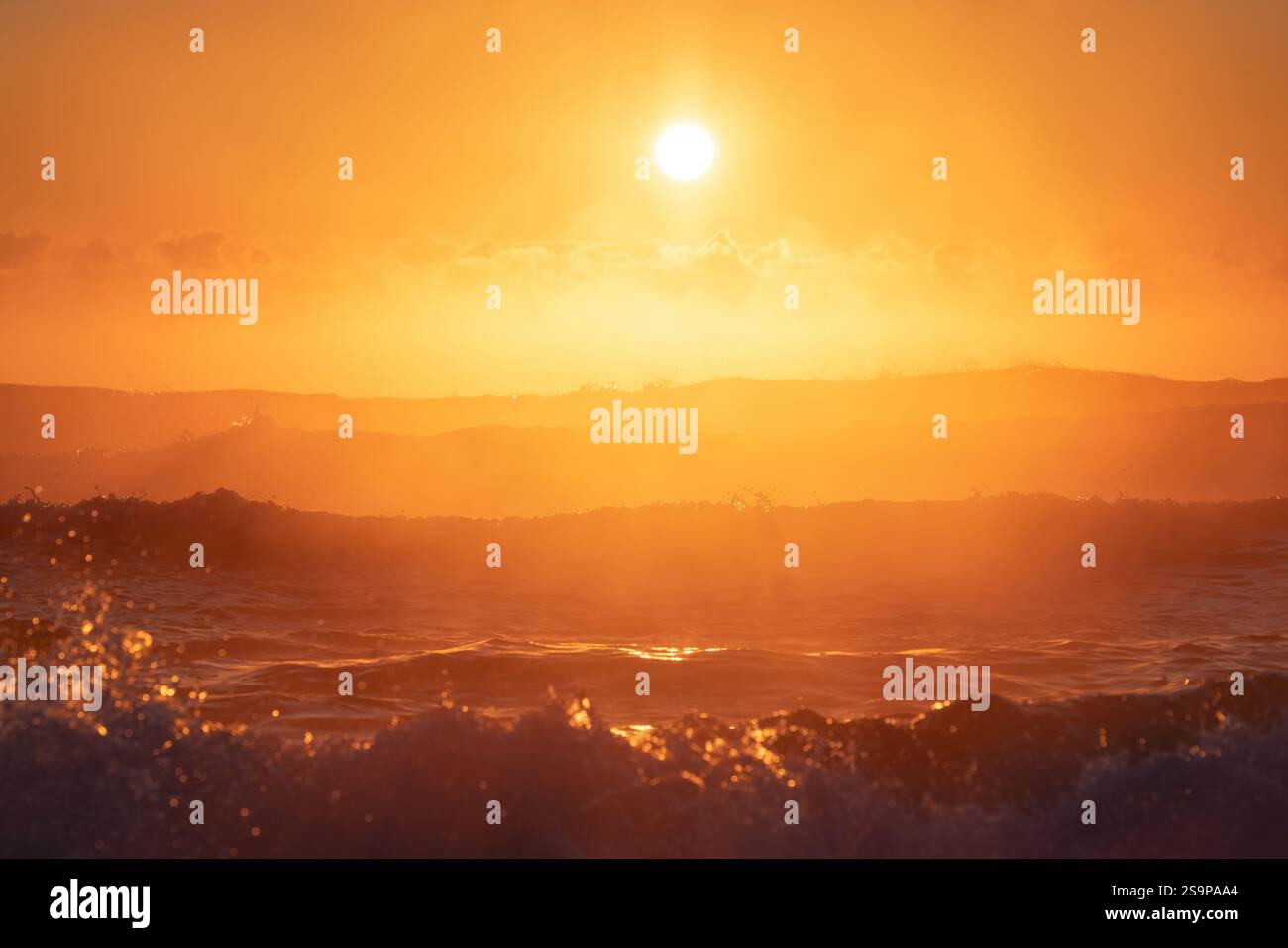 Golden Sunset Over Ocean Waves With Splashes and Mist Stock Photo - Alamy
