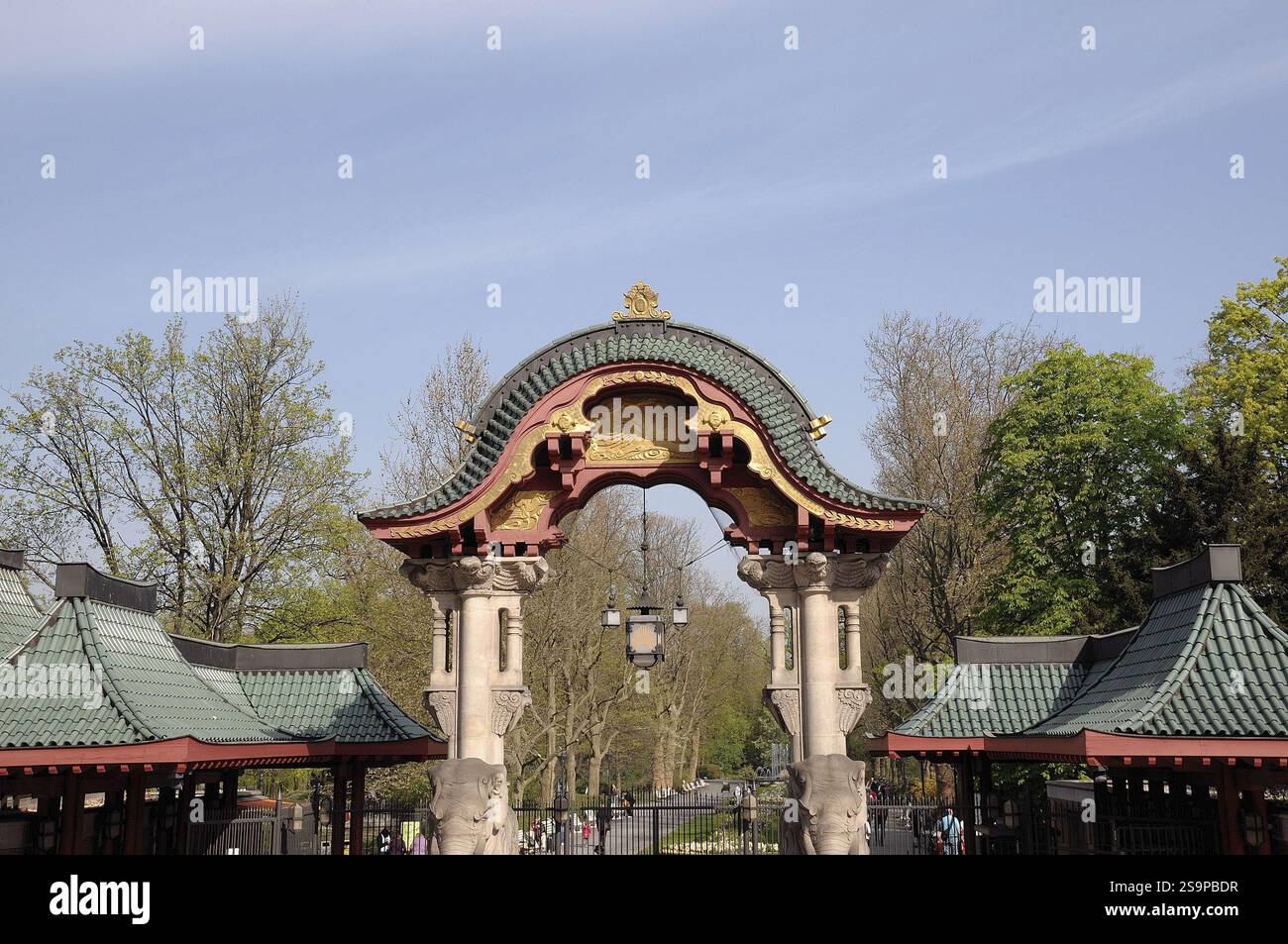 Chinese Tor tor with green roofs surrounded by trees under a blue sky ...