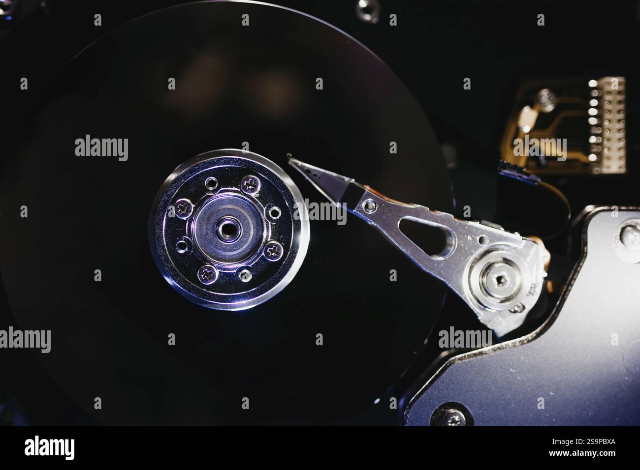 Hard drive with its read-write head poised over the platter ...