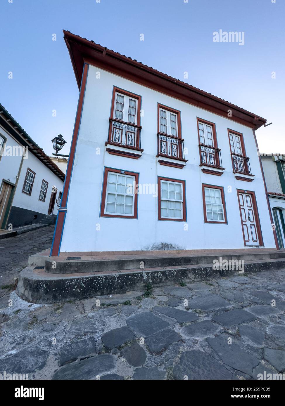 Historic Colonial House on Cobblestone Street at Dusk Stock Photo - Alamy