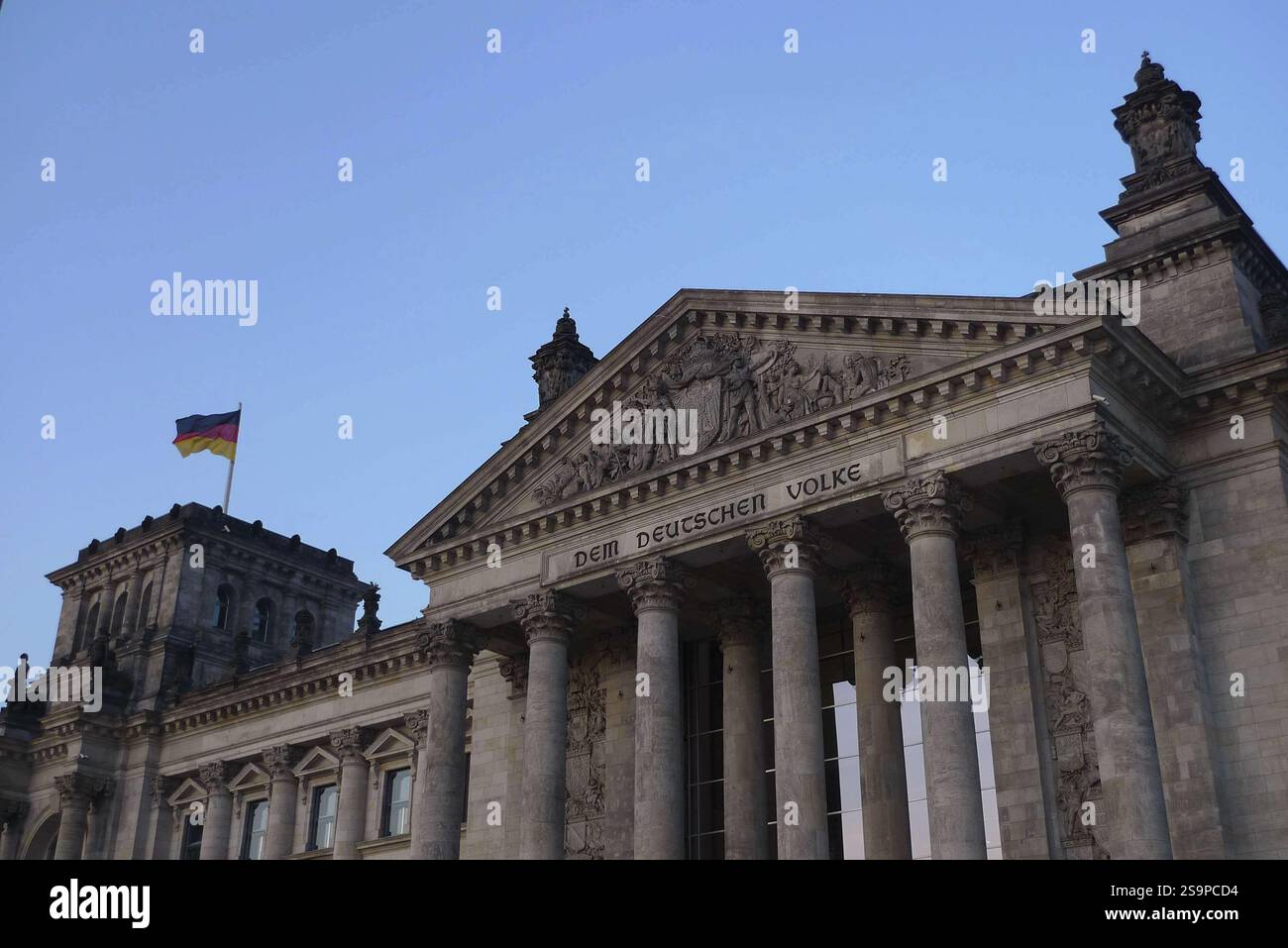 Historic government building with the German flag and imposing columns ...