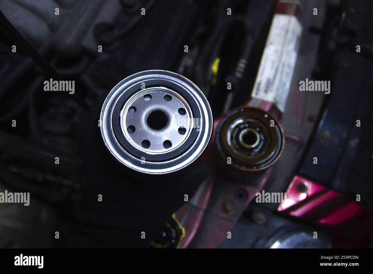 An oil filter is positioned in the engine bay of a car Stock Photo - Alamy
