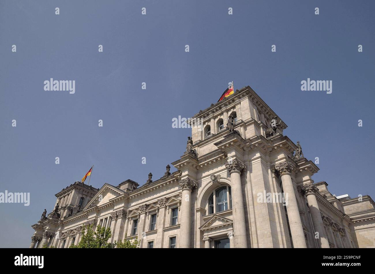 Main building of the Berlin Reichstag with waving German flags and ...