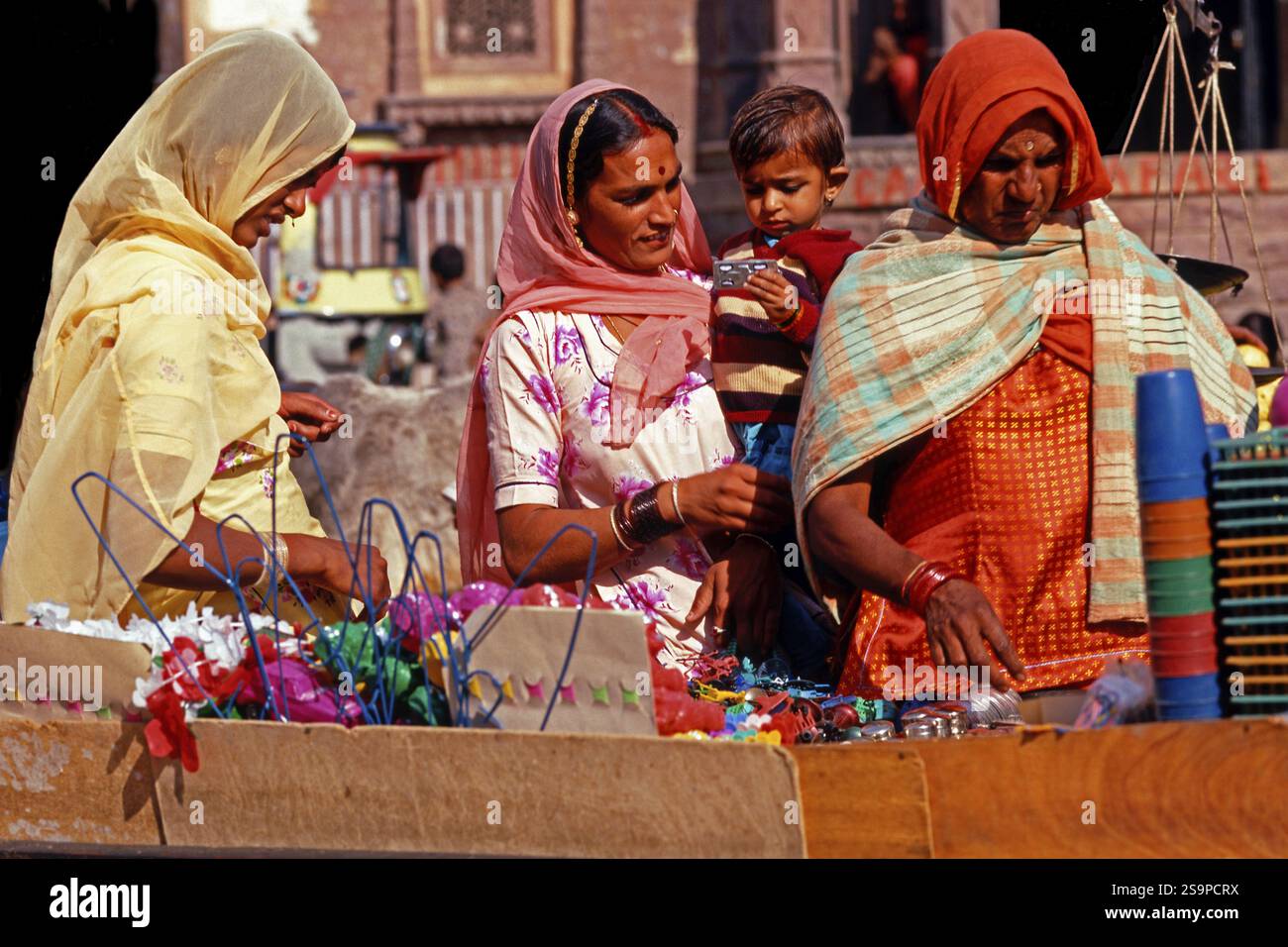 Indian woman examining the goods at a market in Jodhpur, India, Asia ...