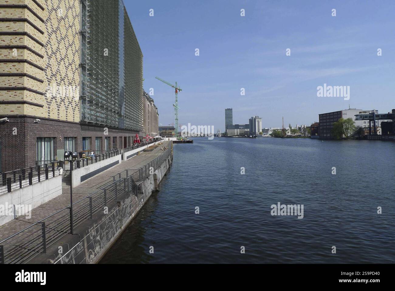 Modern riverside architecture with water and sky, urban and industrial ...