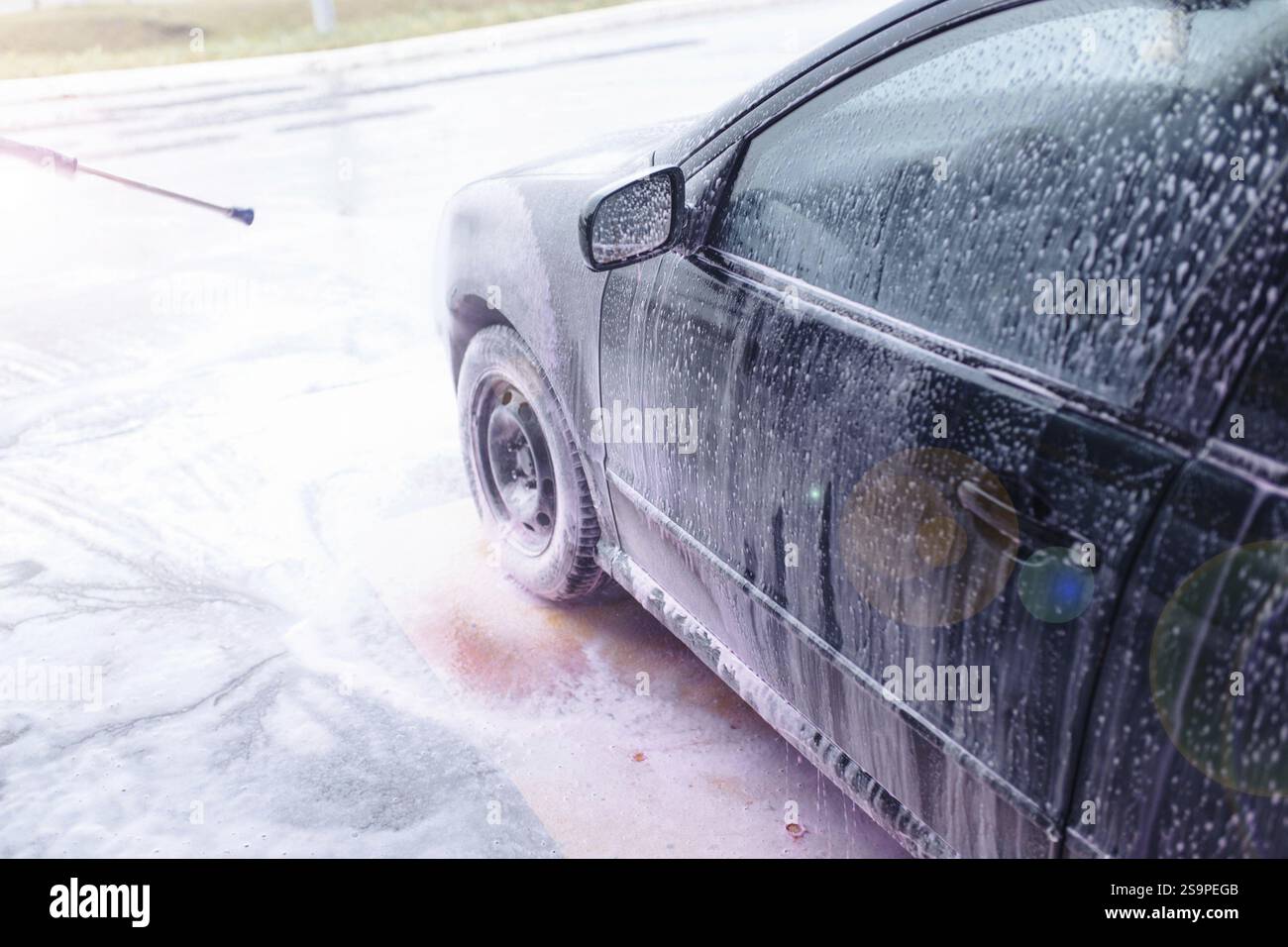 Side view of a car being washed with foam at a car wash Stock Photo - Alamy