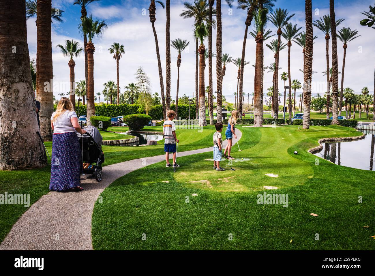 Palm Desert, CA USA - May 6, 2018: Family putting on the mini golf ...