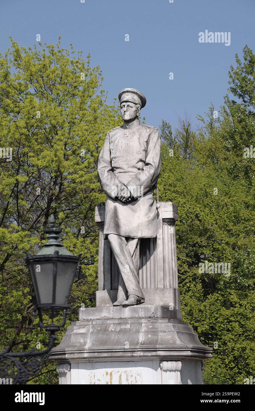 Statue of a man in uniform, flanked by a lantern and trees, Berlin ...
