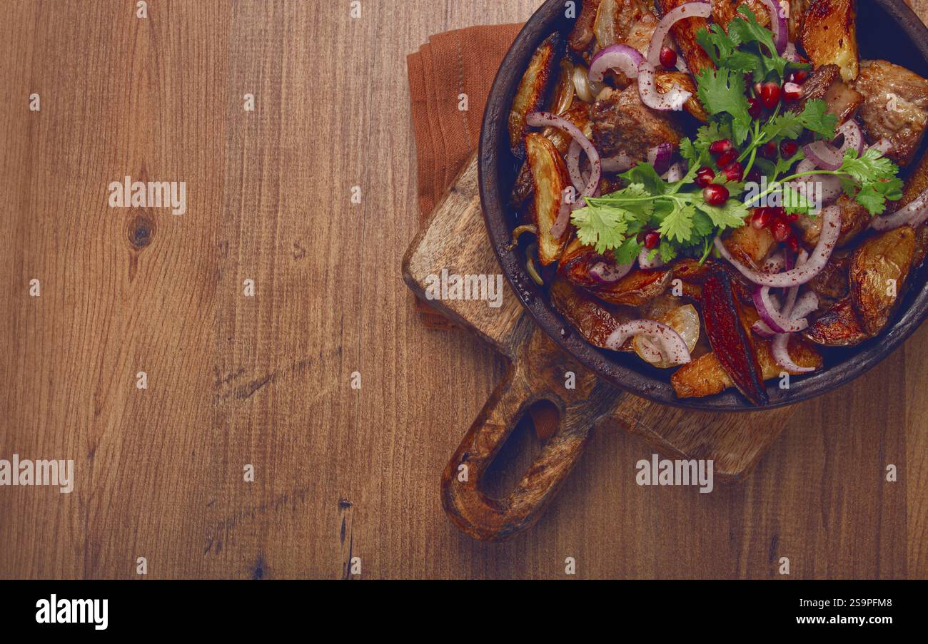 Ojakhuri, a traditional Georgian dish, fried potatoes with meat, in a ...