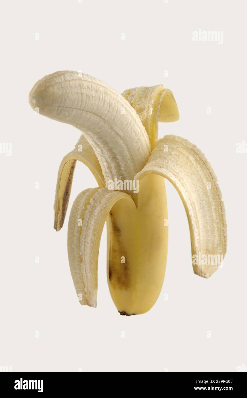 Fruit, half an unpeeled banana on a white background Stock Photo - Alamy