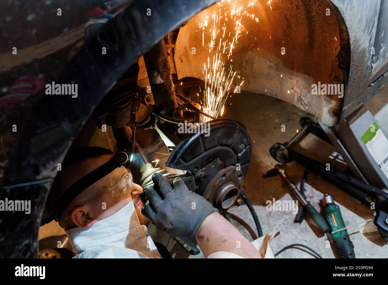 A Mechanic Performing Welding Repairs on a Car Brake System Stock Photo ...