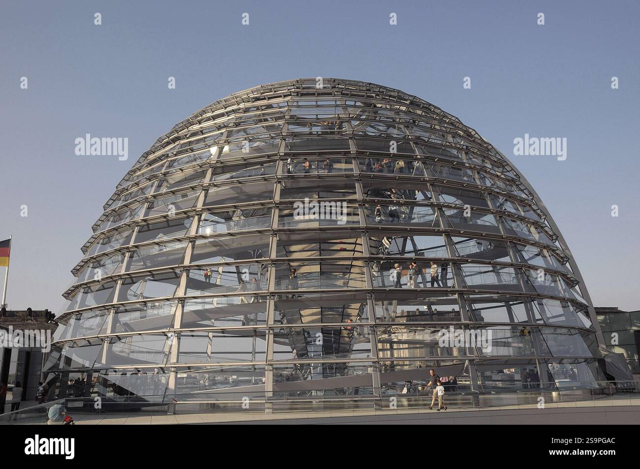Modern glass dome of the Reichstag building in Berlin with visitors in ...