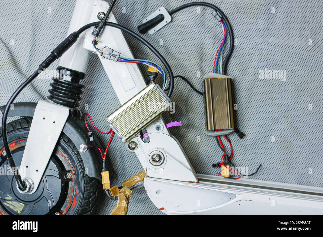Electric scooter with exposed components and wiring, showcasing ...