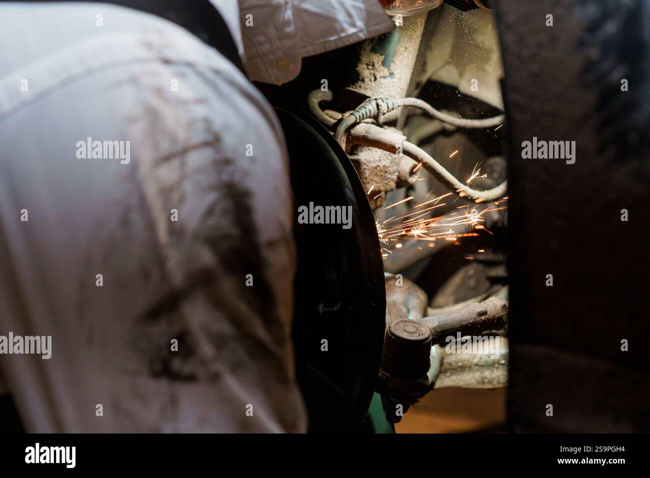Mechanic Cutting Brake Disc with Sparks in Workshop Stock Photo - Alamy
