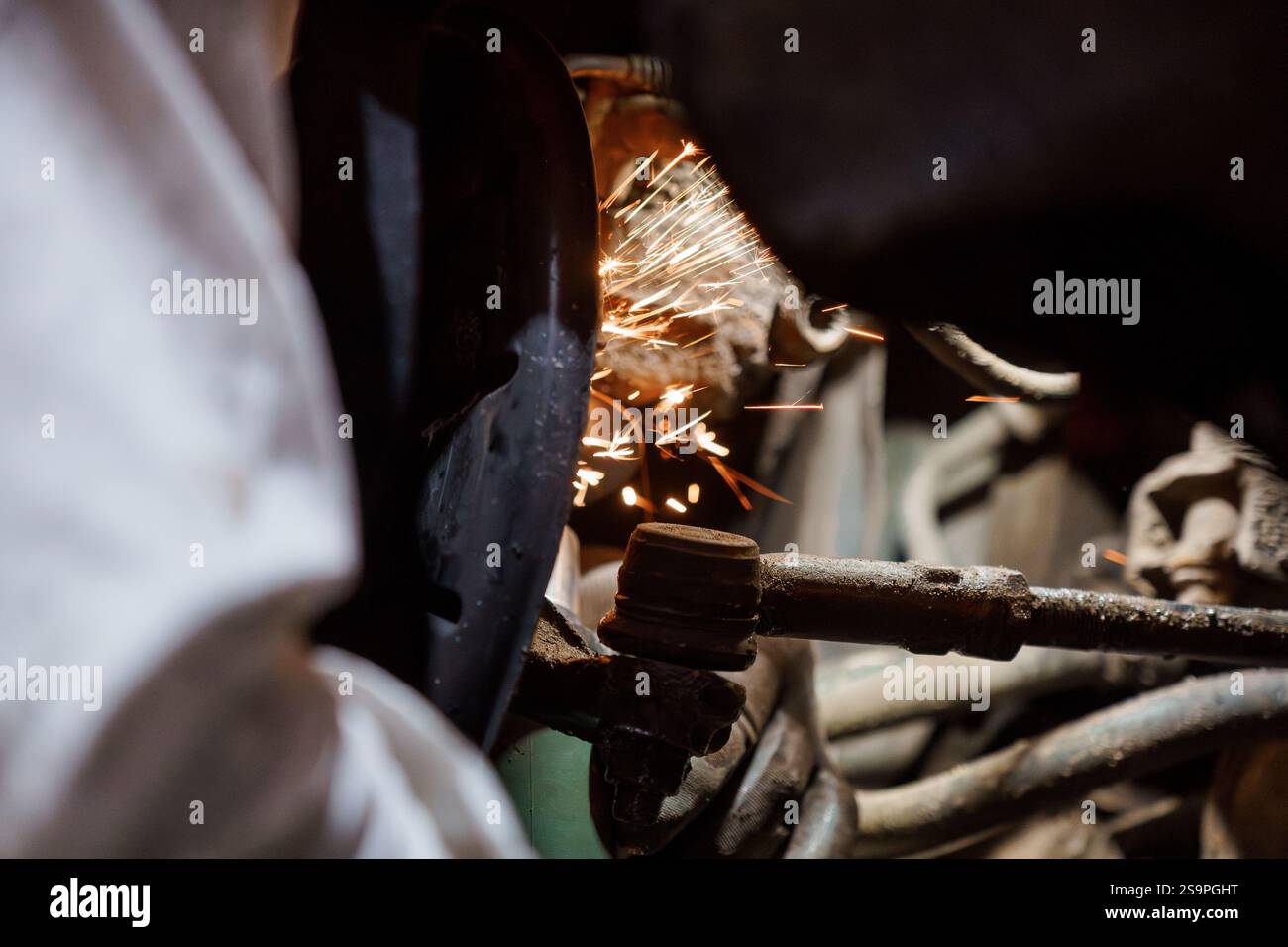 Sparks Flying During Metal Grinding Process in an Automotive Workshop ...