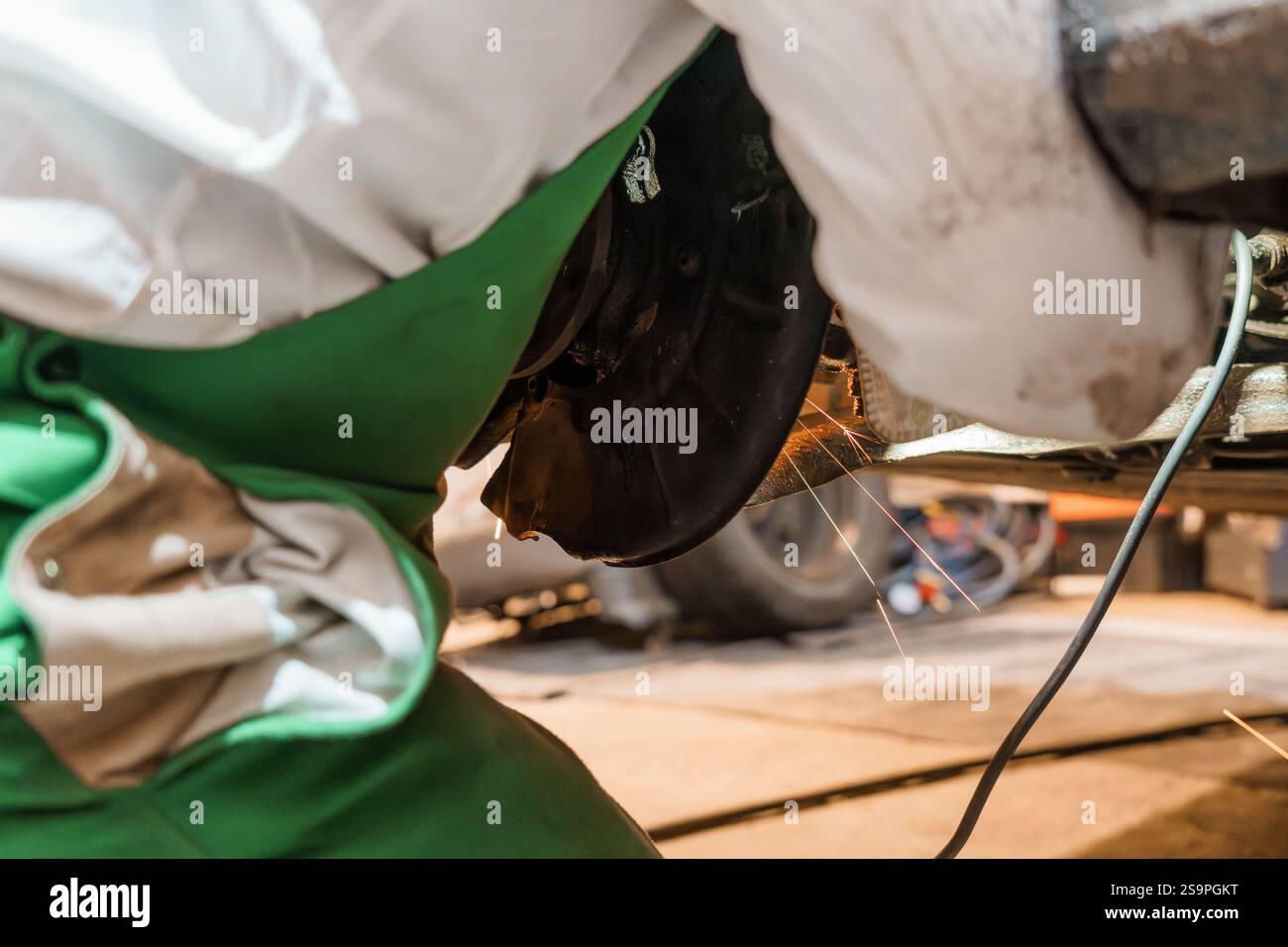 Automotive Technician Welding Underneath Vehicle in Workshop Stock ...