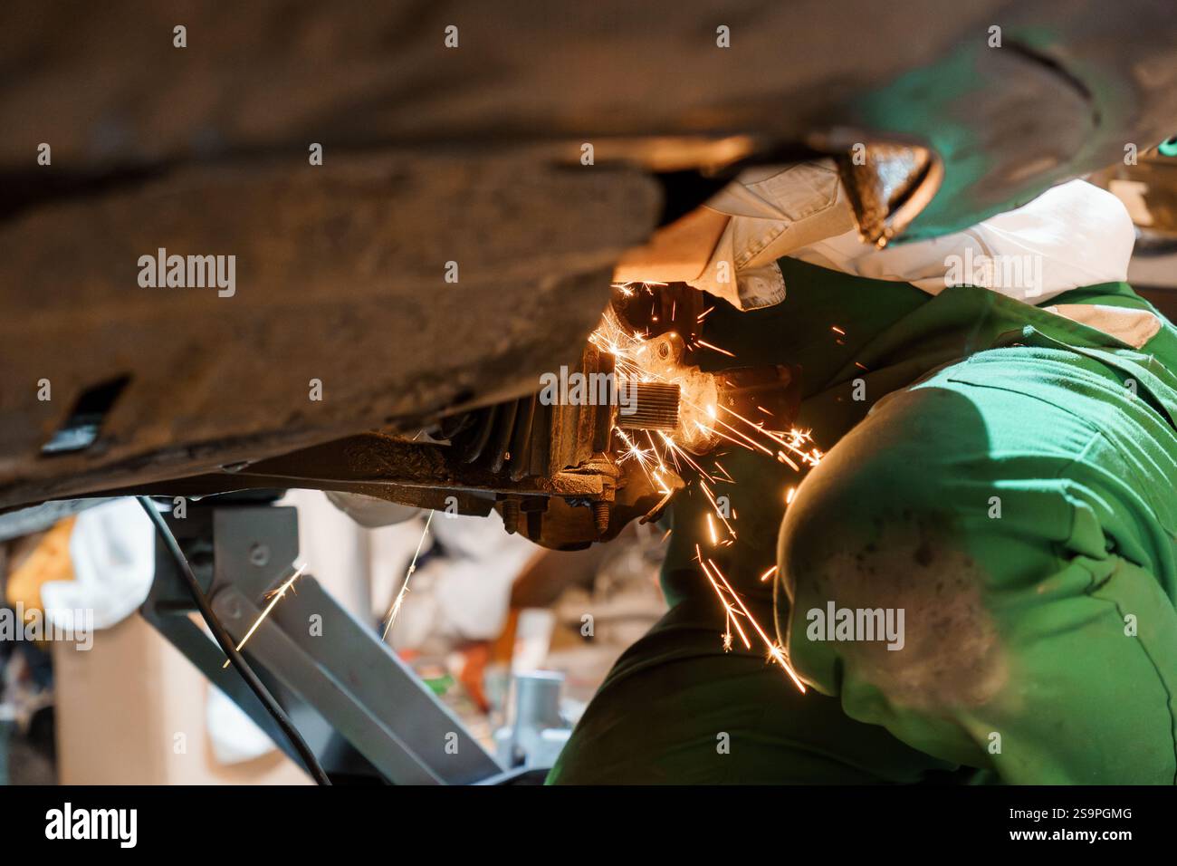 Mechanic Welding Underneath a Vehicle in a Workshop Stock Photo - Alamy