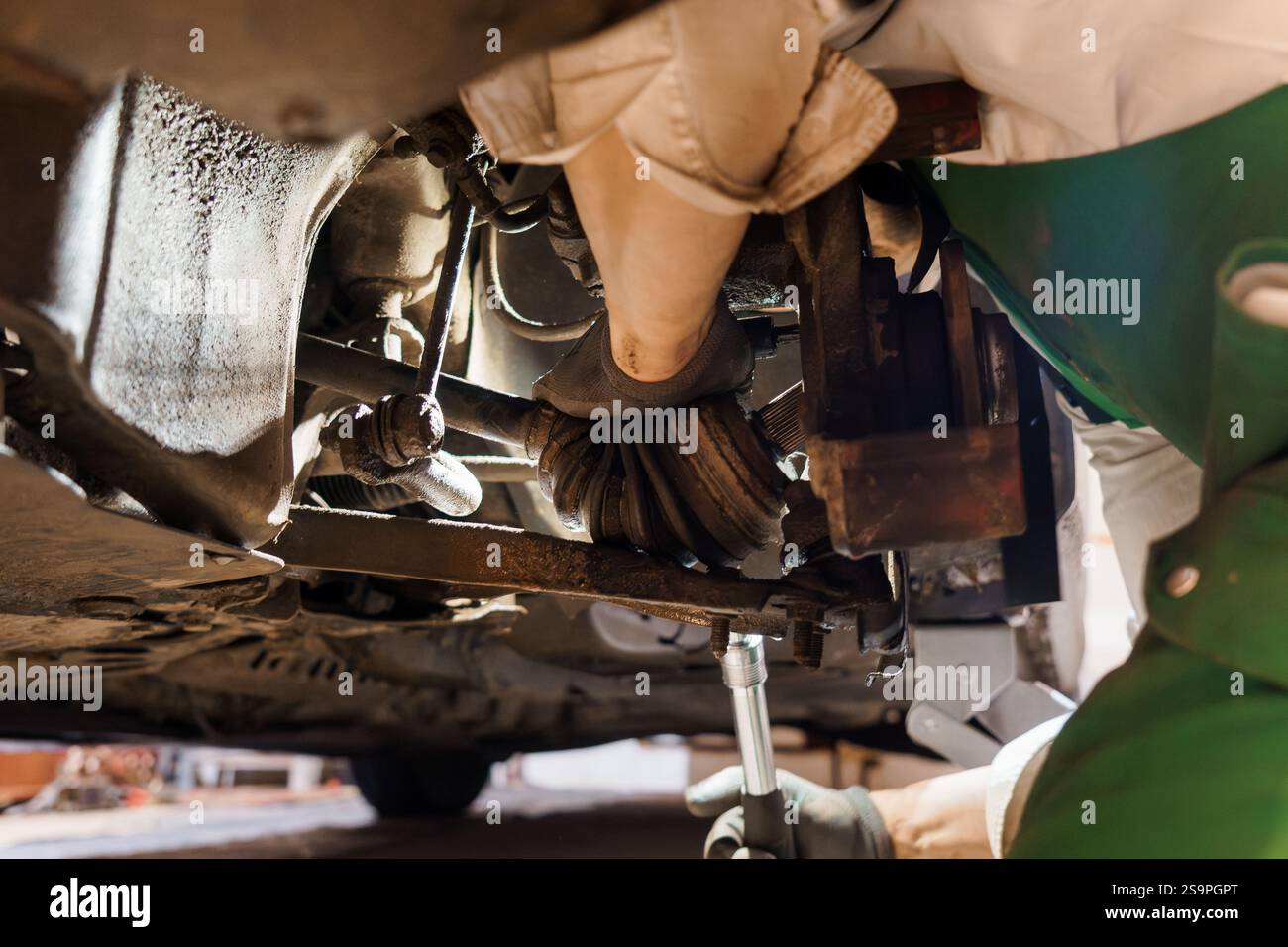 Mechanic Performing Vehicle Maintenance Underneath a Car Stock Photo ...