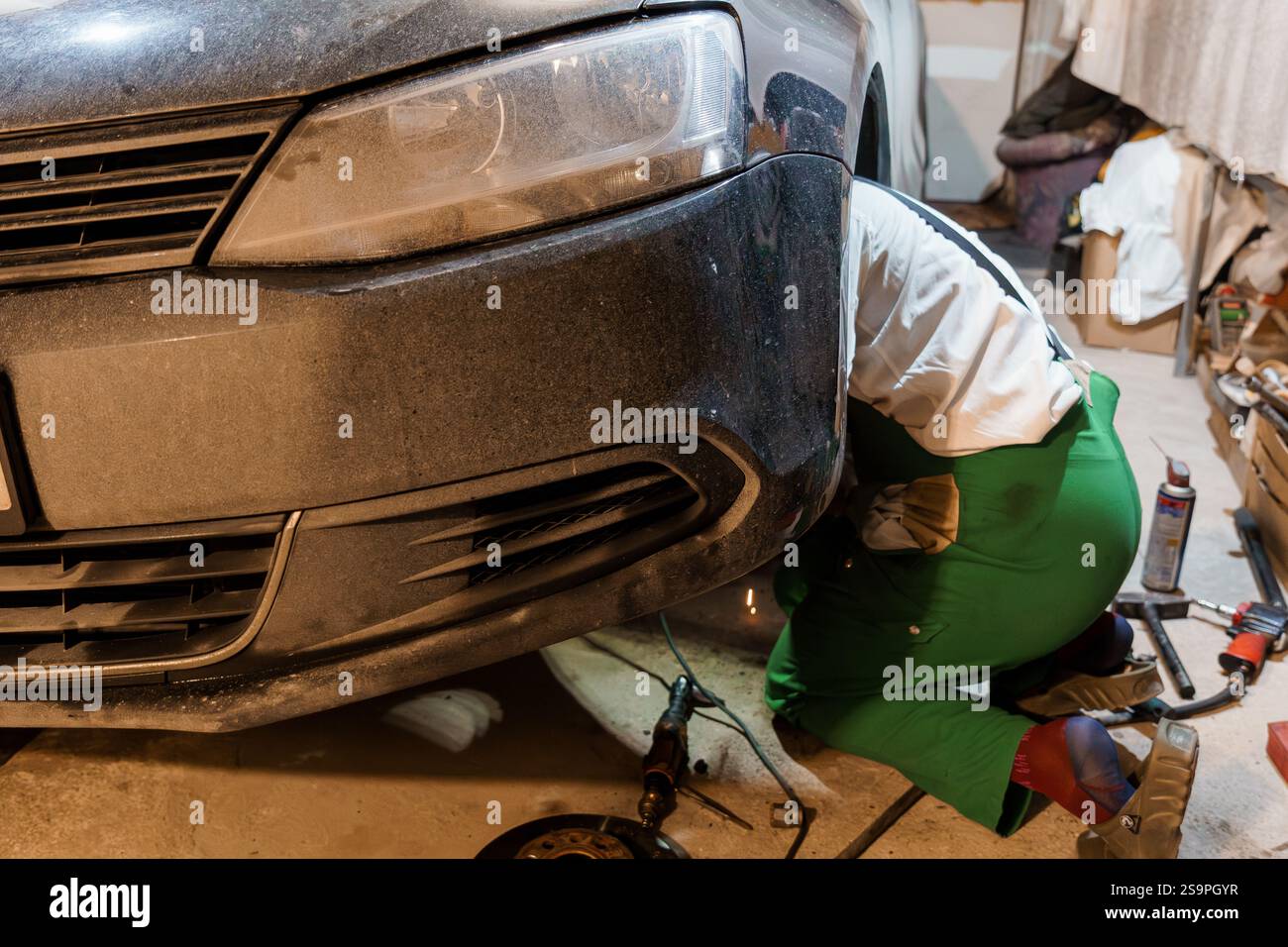 Car Mechanic Working Underneath a Vehicle in a Garage Stock Photo - Alamy