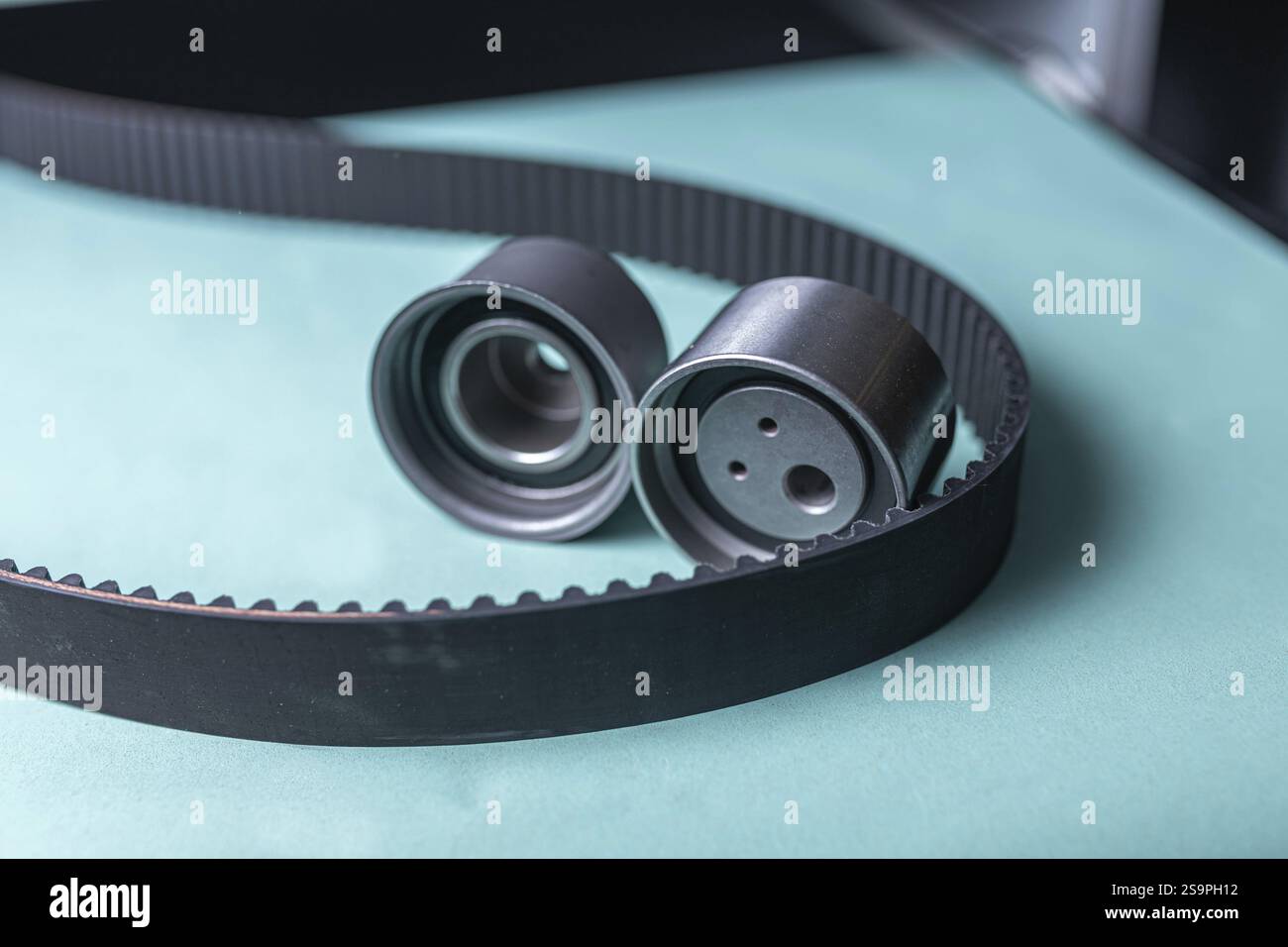 Timing belt and gears placed with focus on mint green background Stock ...