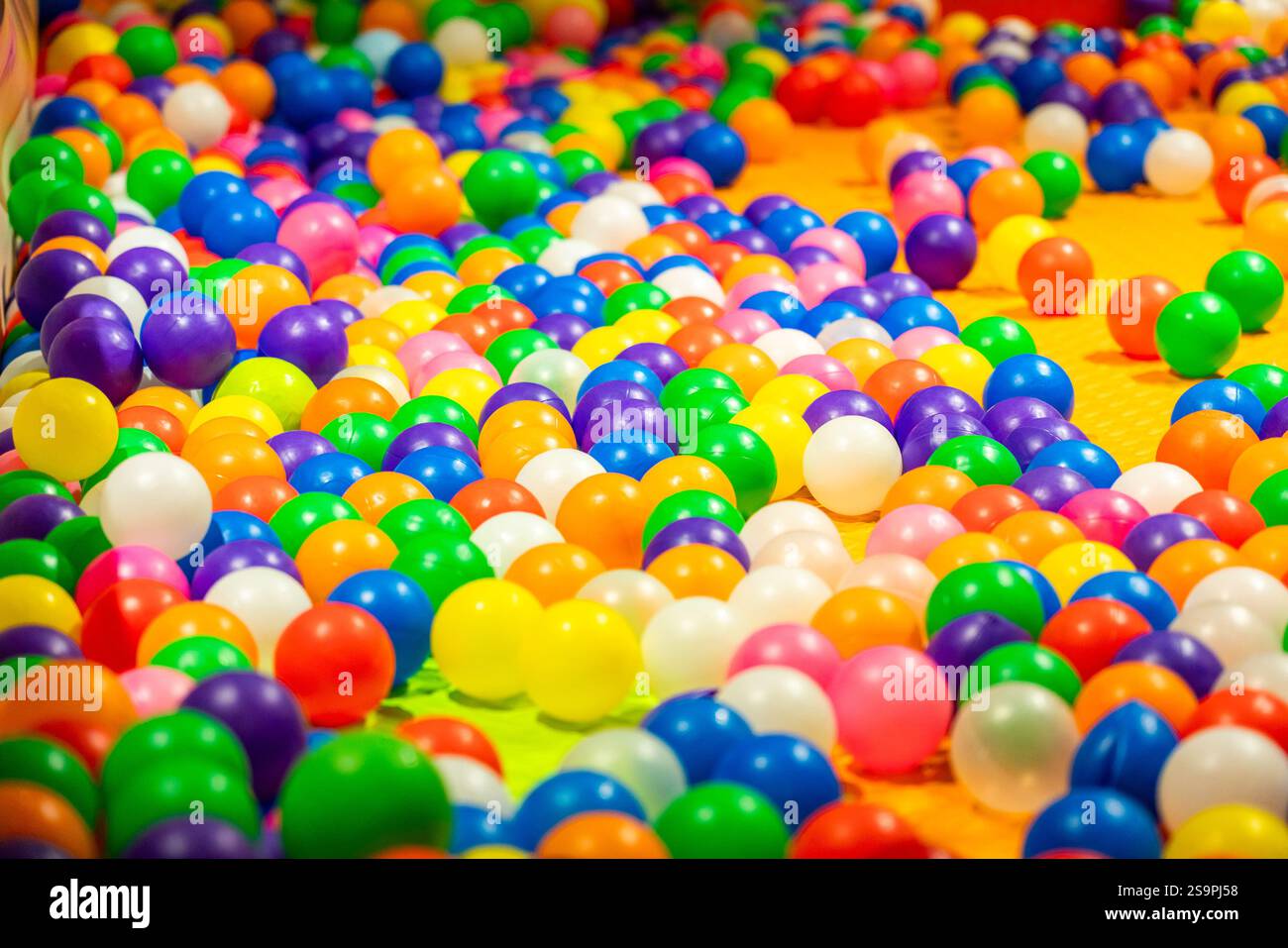 A lively ball pit filled with colorful plastic balls for endless fun ...