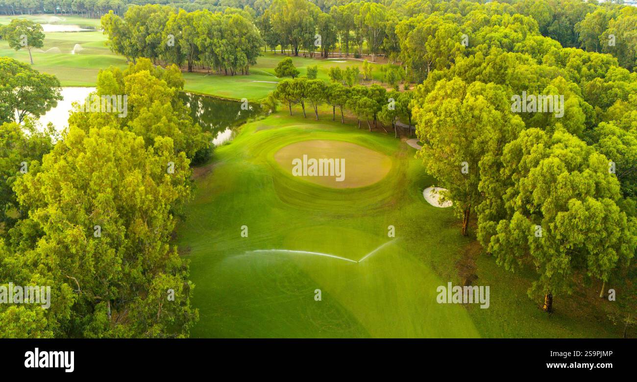 An aerial view of a golf course with vibrant greenery and a tranquil ...