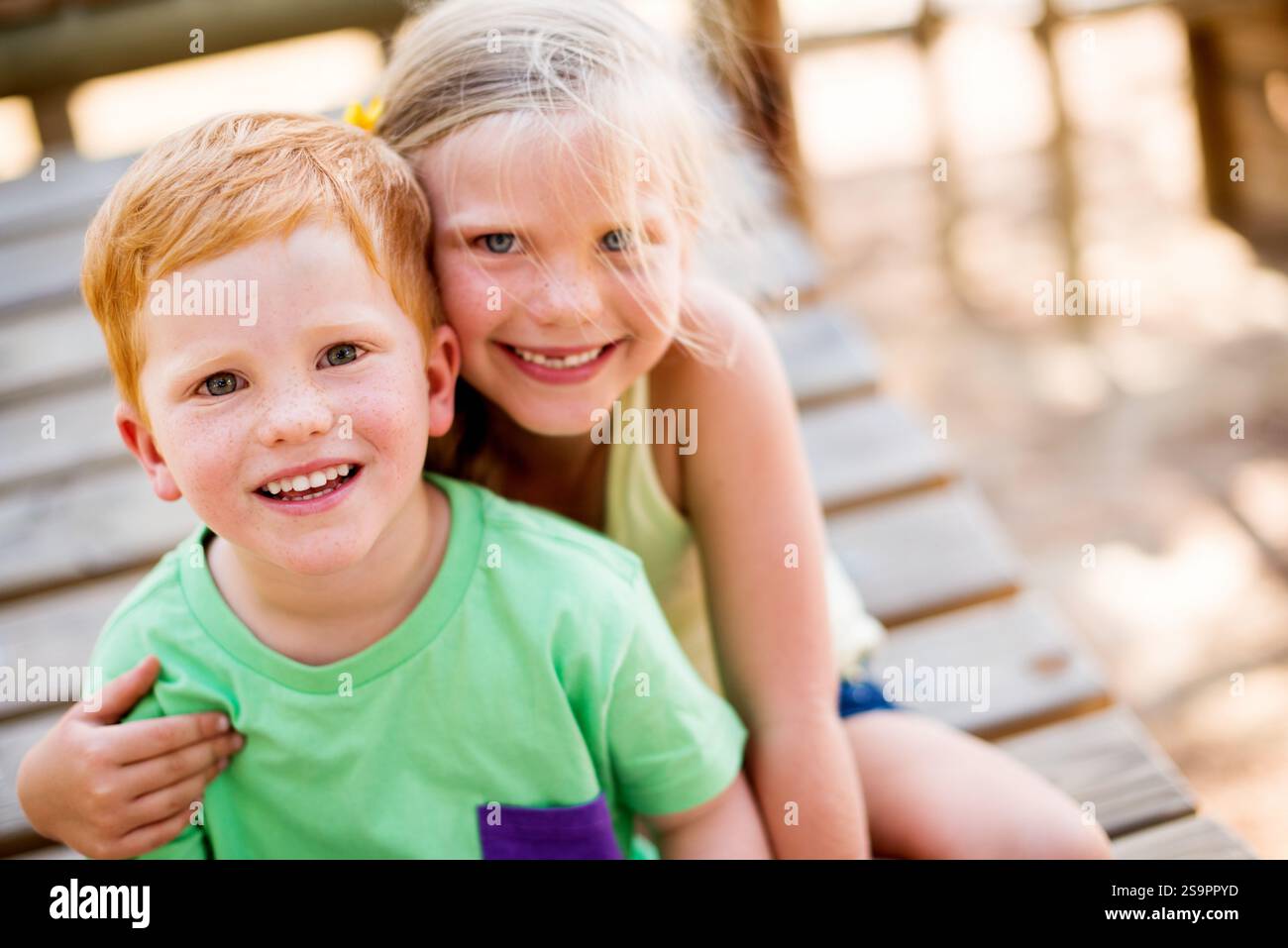Smile, portrait and children hugging in park for bonding, connection or ...