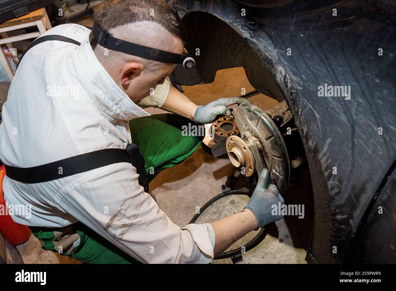 Mechanic Performing Brake Repair Underneath Vehicle in Garage Stock ...