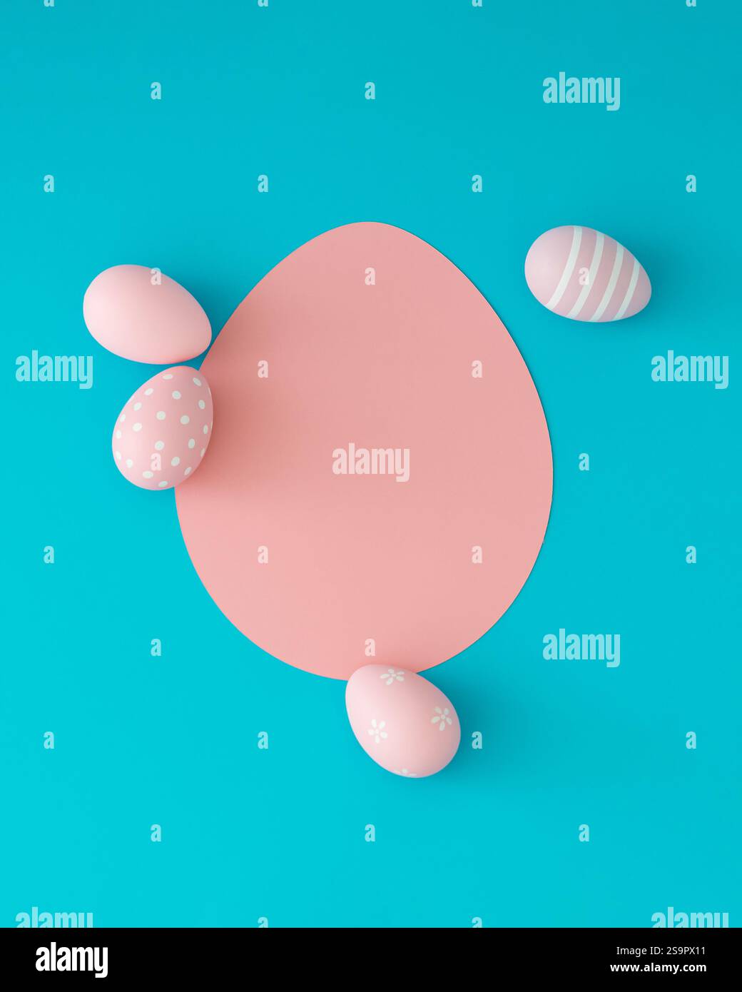 Pink colored eggs on light blue background with egg shaped paper card ...