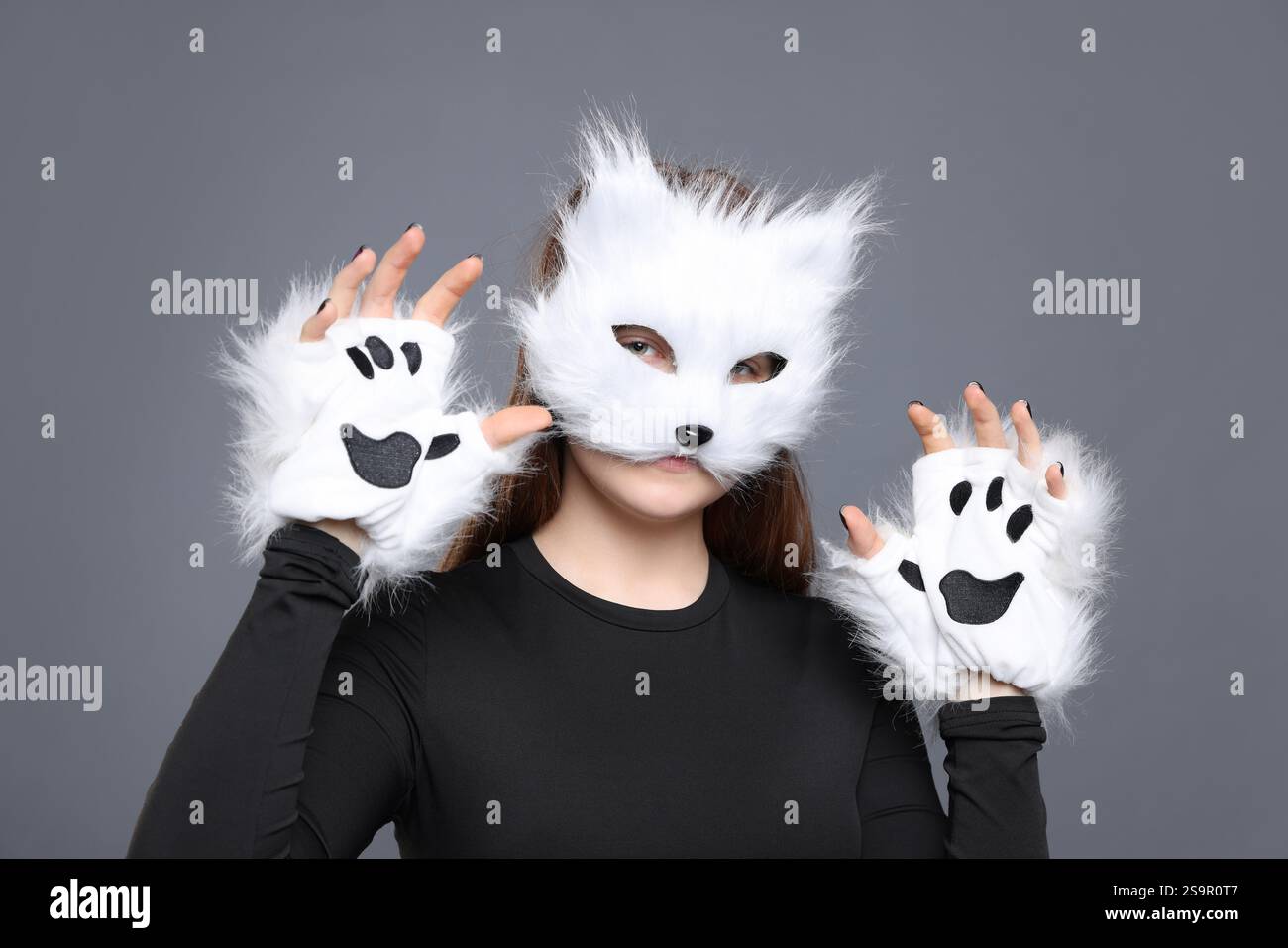Quadrobics. Girl wearing cat mask and gloves on grey background Stock ...