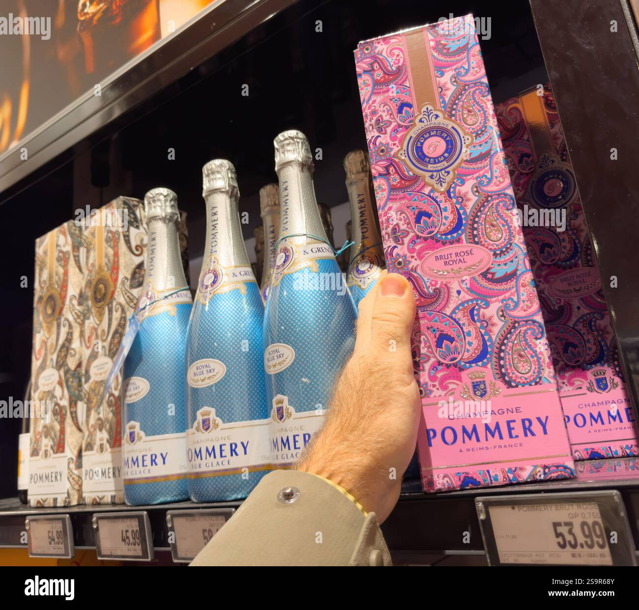 Frankfurt, Germany - Dec 30, 2024: A hand picking a Pommery Brut Rosé ...