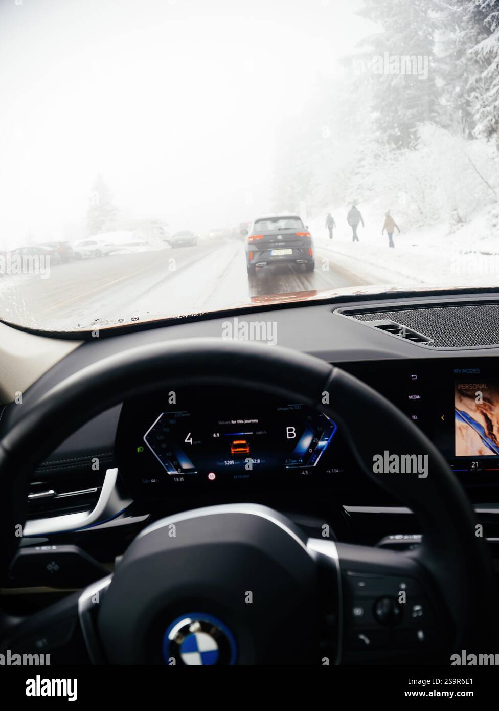 Black Forest, Germany - Jan 3, 2025: BMW dashboard view showing a snowy ...