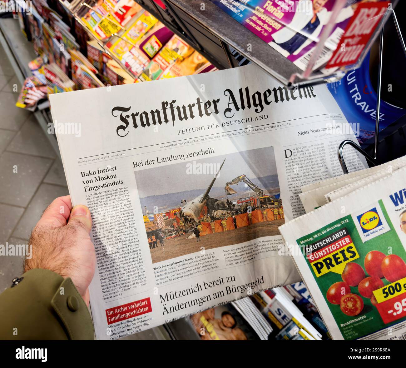 Frankfurt, Germany - Dec 30, 2024: A person holding a copy of the ...