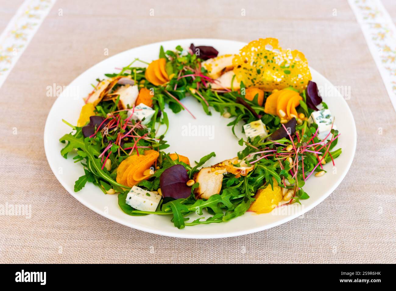 A beautifully crafted salad features fresh greens, vibrant roasted ...