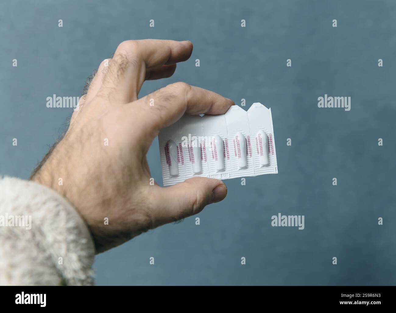 Paris, France - Jan 18, 2025: A hand holding a strip of individually ...