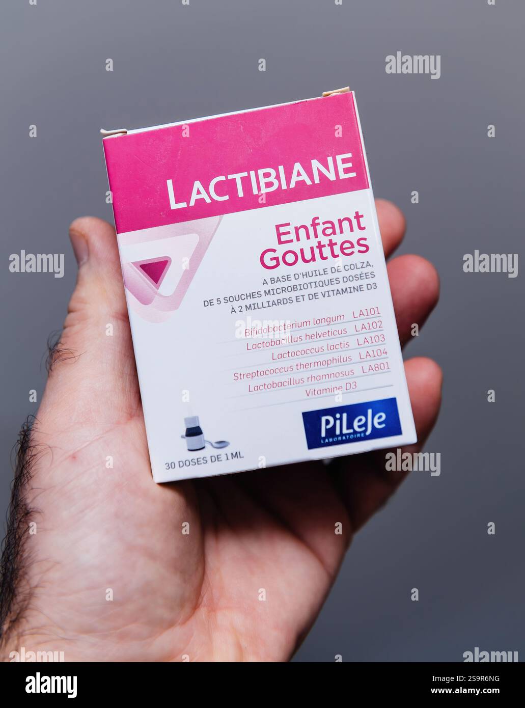 Paris, France - Jan 18, 2025: A hand holding Lactibiane Enfant drops ...