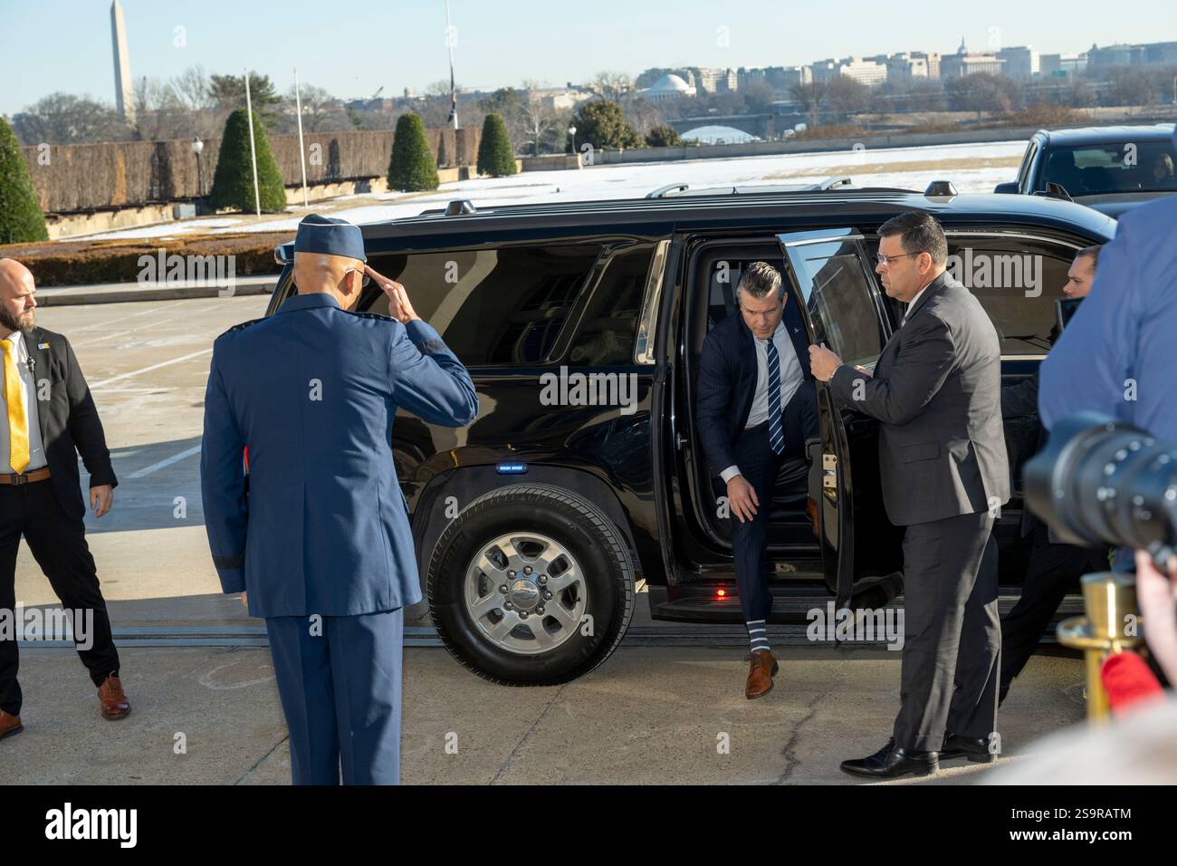 Defense Secretary Pete Hegseth, center, is saluted by Chairman of the Joint Chiefs of Staff Gen ...