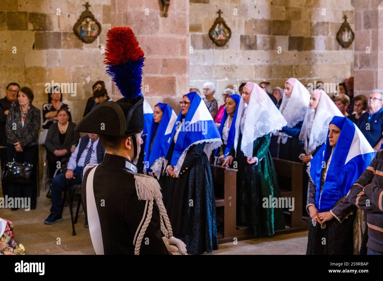 Traditionally dressed people in the church of Santa Maria di Montserrat ...