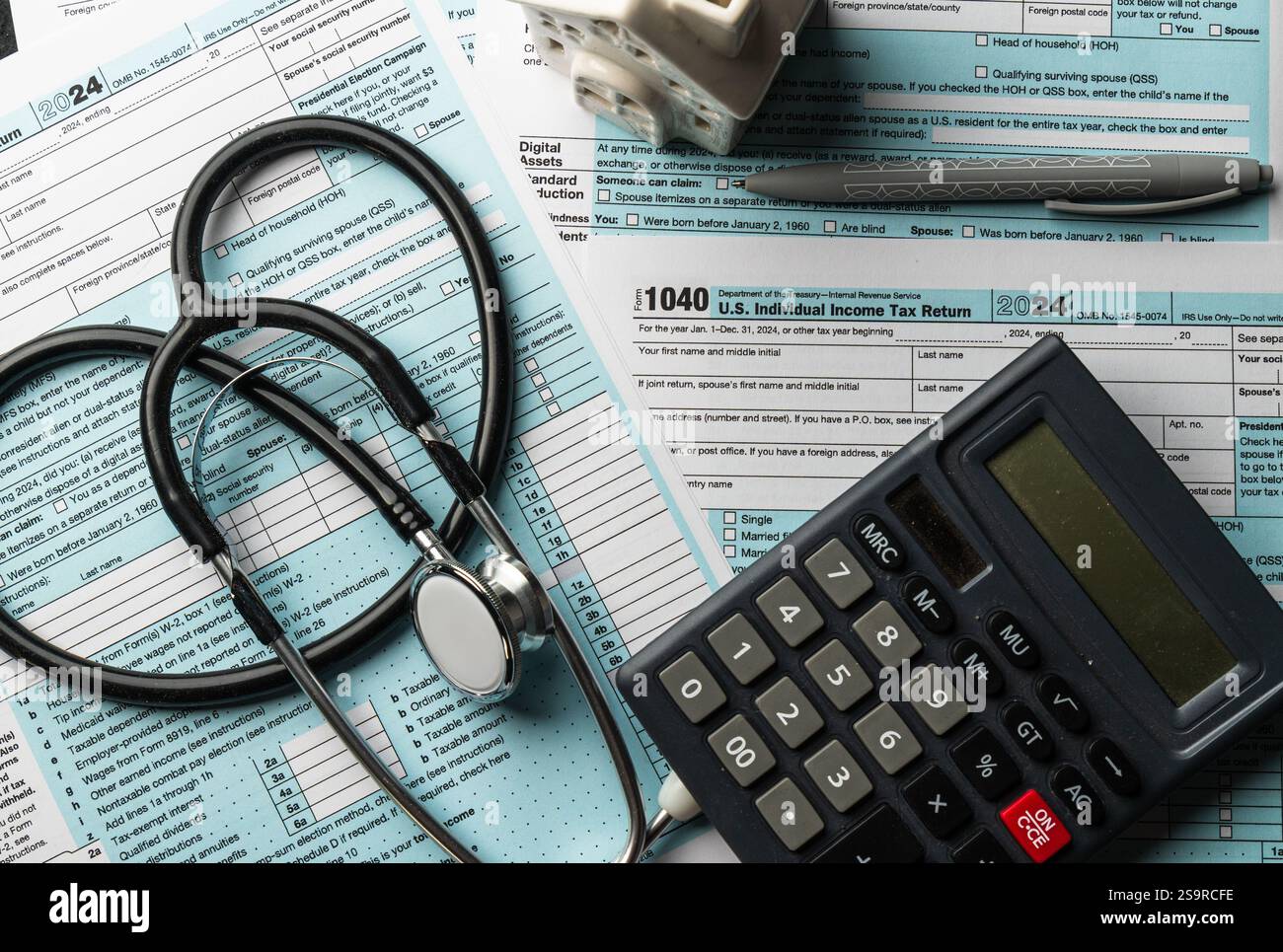 Federal income tax return preparation with 1040 form and calculator for ...