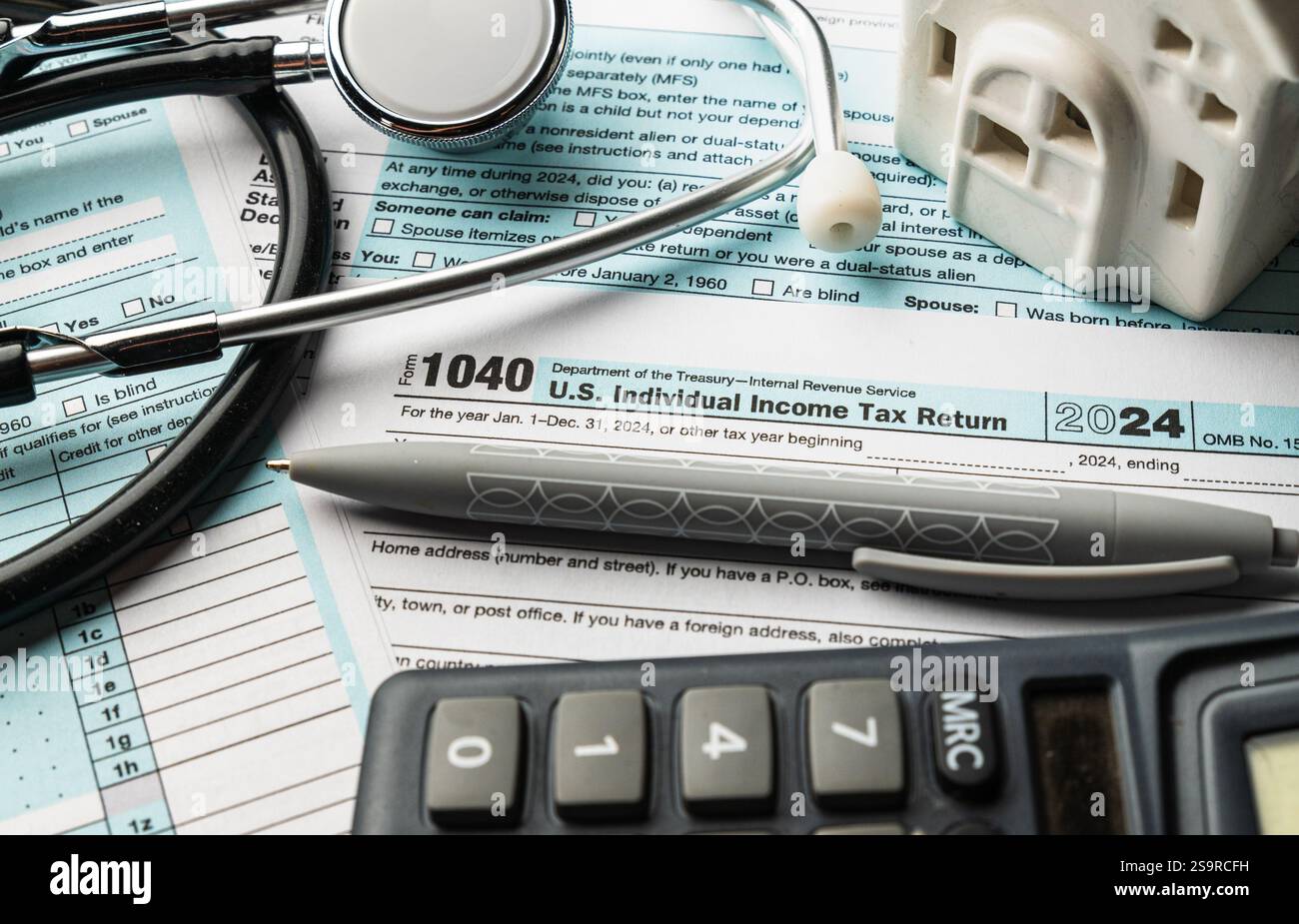 Federal income tax return preparation with 1040 form and calculator for ...