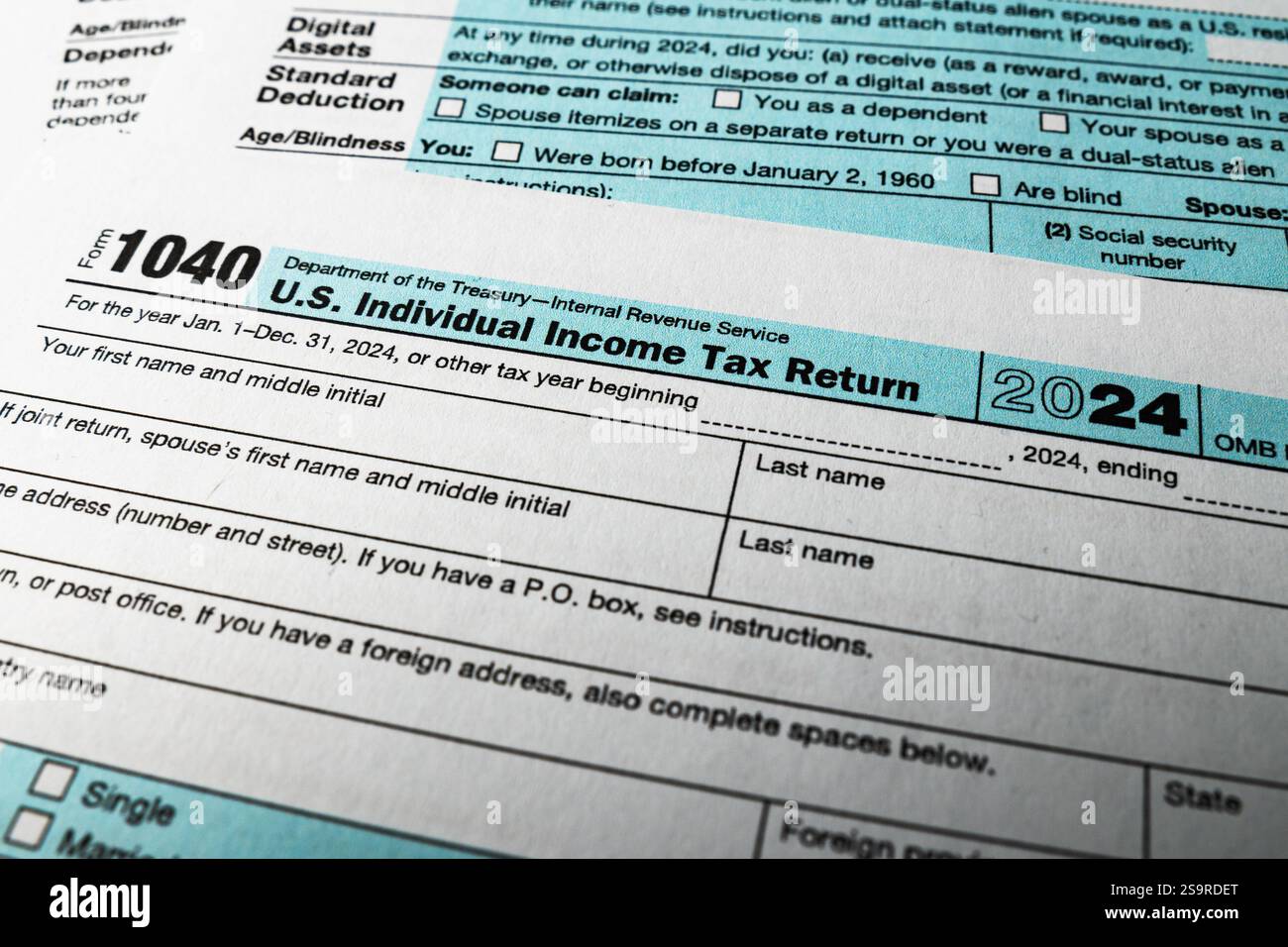 Federal income tax return preparation with 1040 form and calculator for ...