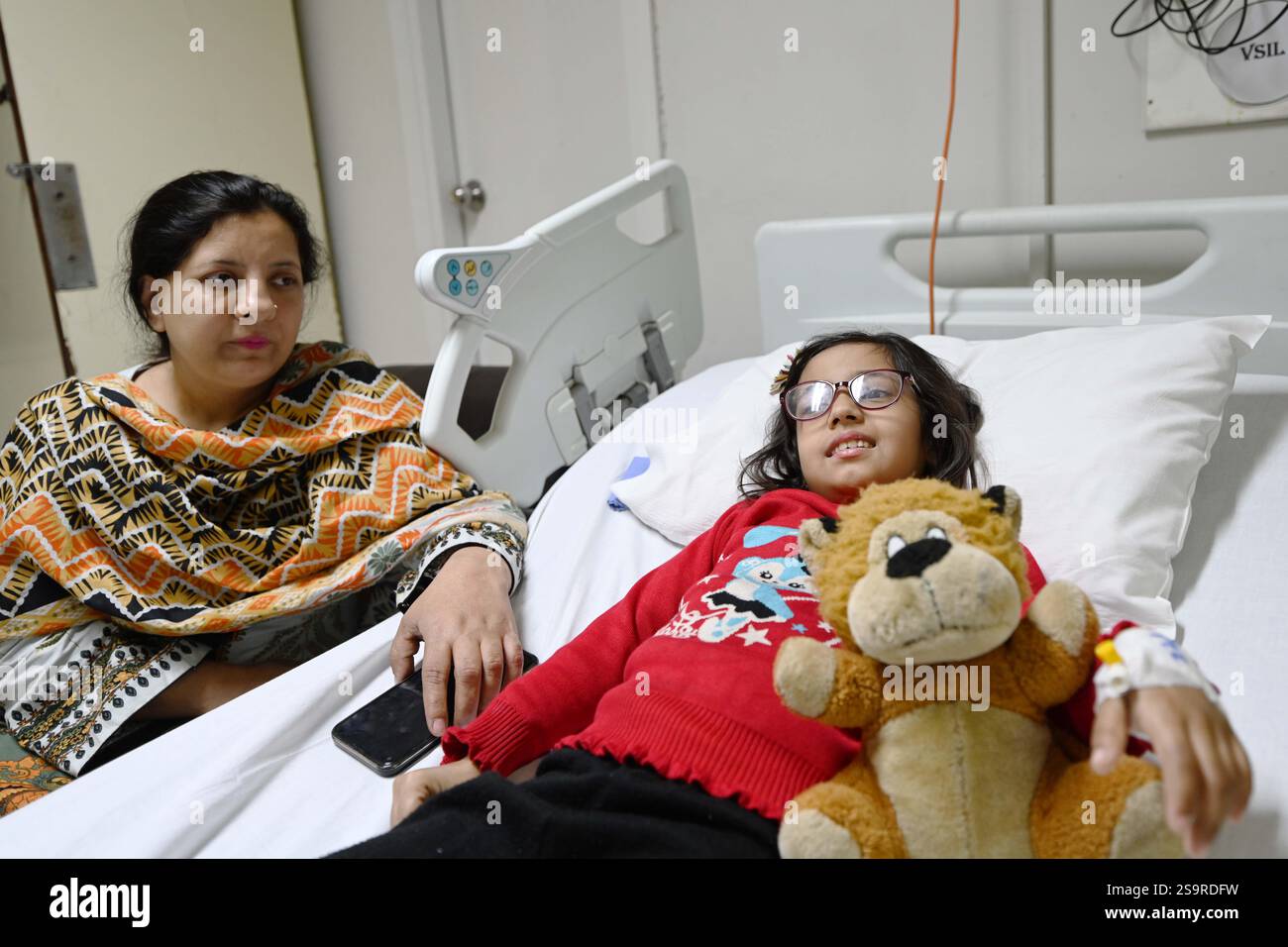 Rawalpindi. 23rd Jan, 2025. A mother takes care of her child after a ...