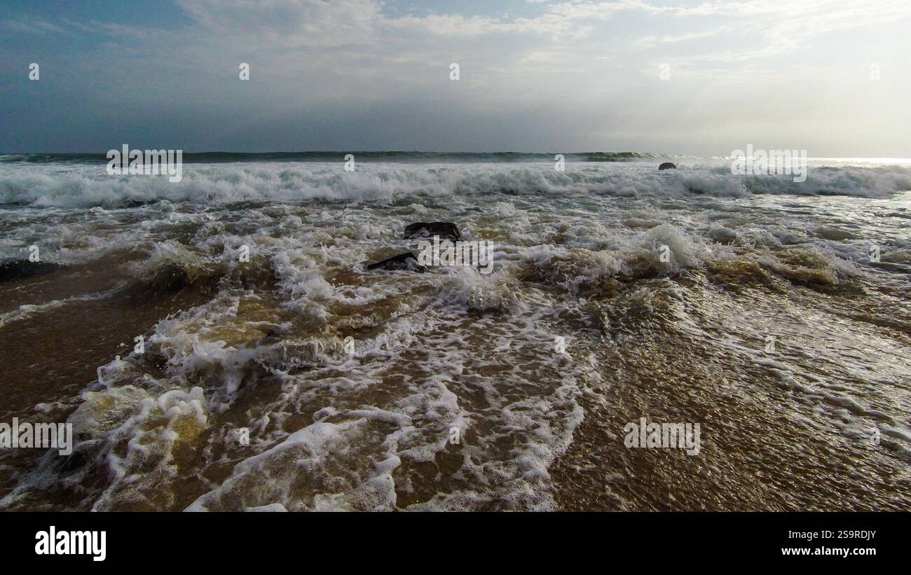 Beach with red sand, red rocks, and a dramatic sky in Congo Town ...
