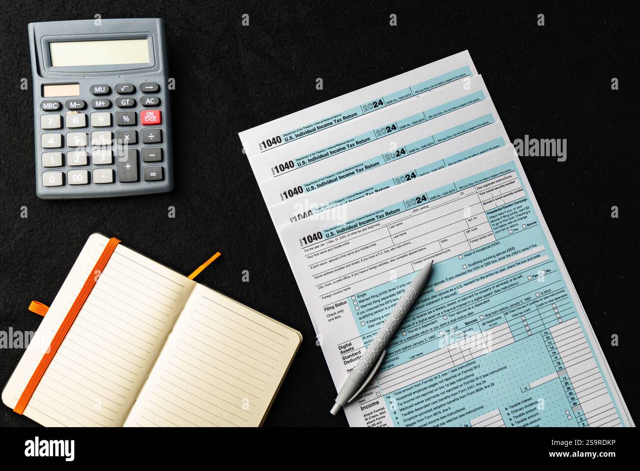 Federal income tax return preparation with 1040 form and calculator for ...
