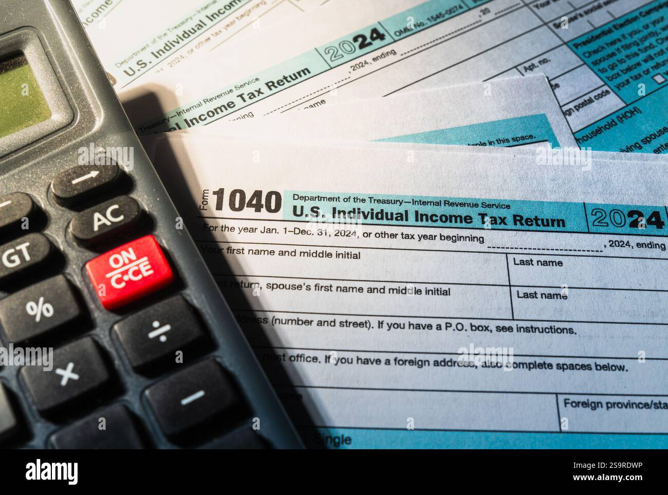 Federal income tax return preparation with 1040 form and calculator for filing season Stock ...